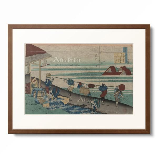 Hokusai Katsushika, 1760-1849.Print shows two men carrying baskets suspended from a long shoulder pole approaching a bui...