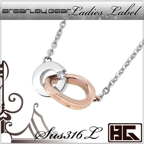 【Brearley Gear/ブレアリーギア】ステンレス地そのままのリングとピンクゴールド色のリング、２つのリングがリンクしたデザインのネックレスです。片方のリングは途中で切れており、その切れた部分を橋渡しするように四角いジルコニアが輝いて...