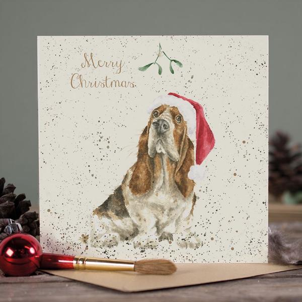 "Merry Christmas"表紙に金箔押し加工の文字が入った、美しい動物イラストのクリスマスカードです。"Mistletoe"（ヤドリギ）ヤドリギの葉をじっと見つめる可愛いバセットハウンド。（イギリスやアメリカでは、クリスマスシーズン...