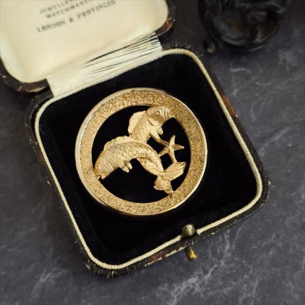 ■size直径約3.7cm1969年に発売されたAstrological（占星術）シリーズより、魚座のブローチ。ゆるやかに泳ぐ2匹の魚とヒトデのモチーフが幻想的でどこか物語を感じさせるデザインです。立体感のある魚の造形や、細やかなテクスチャ...