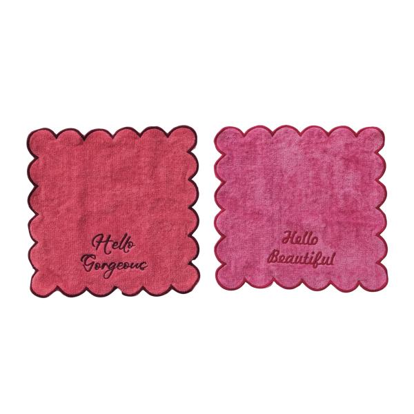 ・A pair of pink square cotton bath towels, each featuring a unique embroidered saying that adds a personal touch・An ecle...