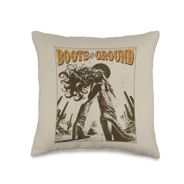 ・Unique western-themed graphic featuring a cowgirl gunslinger and "Boots on the Ground" slogan. Retro distressed design ...