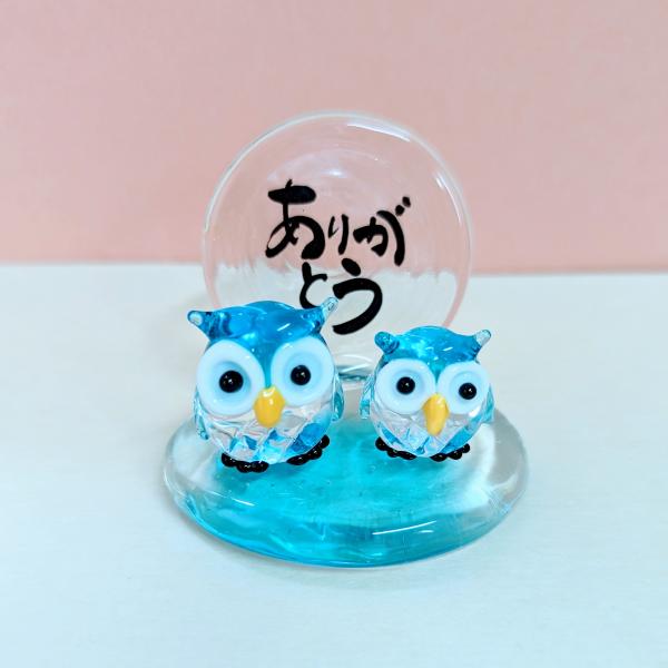 ふくろうありがとうペア台（青）のガラス細工の置物です。【大きさ】約高さ４０ミリ　　横幅４５ミリ　　　　　奥行４５ミリ＊商品は一つ一つ手造りのため大きさや色合いなどが写真と異なる場合がありますのでご了承をお願い致します。
