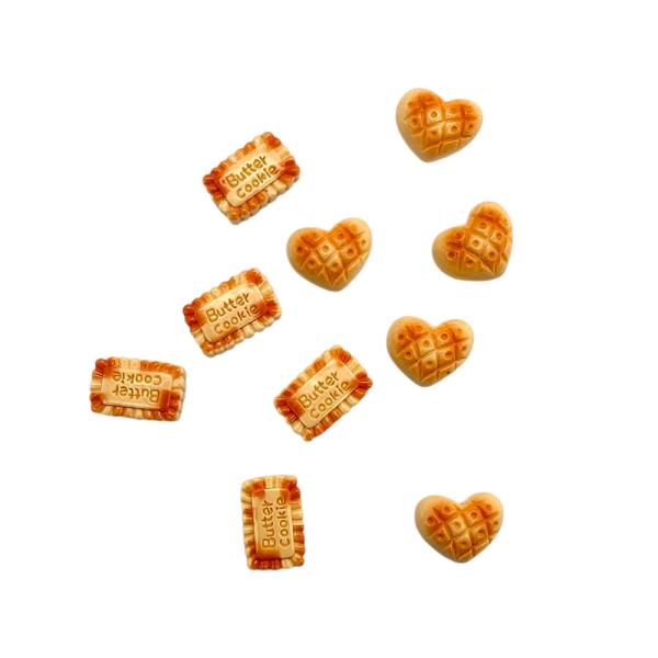クッキー風のアクリルパーツです。少し焼き後があるような可愛いクッキーです。小さめなのでワンポイントで貼り付けやすいです。ヘアゴムや、お子様の服飾などワンポイントで付けたりといろいろな活用ができるアイテムになってます。いろいろなな用途でご使用...