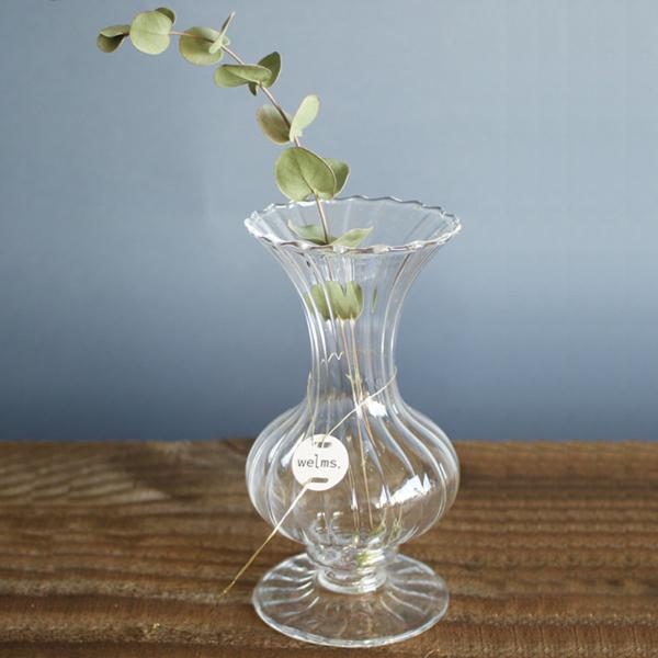 サイズ/約高さ12cm直径：約6cm内容量/1個材質/ガラス●挿すだけで花を美しく見せる一輪挿しです。●お部屋の片隅に置ける、手のひらサイズです。●様々なお部屋に調和する清楚なガラス製です。●揃えておしゃれに飾るwelms.シリーズです。●...