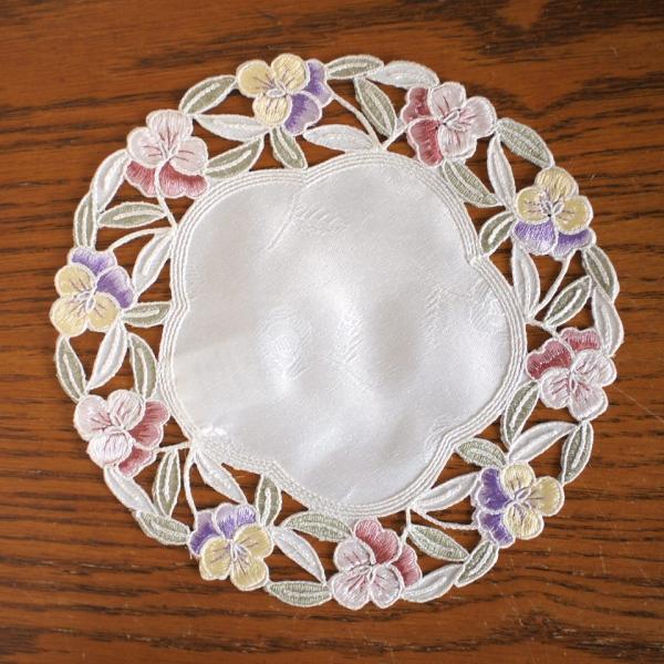 花瓶敷きやキャンドルマット、小さなテーブルセンターとして使える上品なレースドイリーです。おしゃれなアンティークレース風の刺繍レースドイリー「ビオラポット」です！  上品なオフホワイトカラーが、インテリアを一層引き立て、お部屋に優雅な雰囲気を...