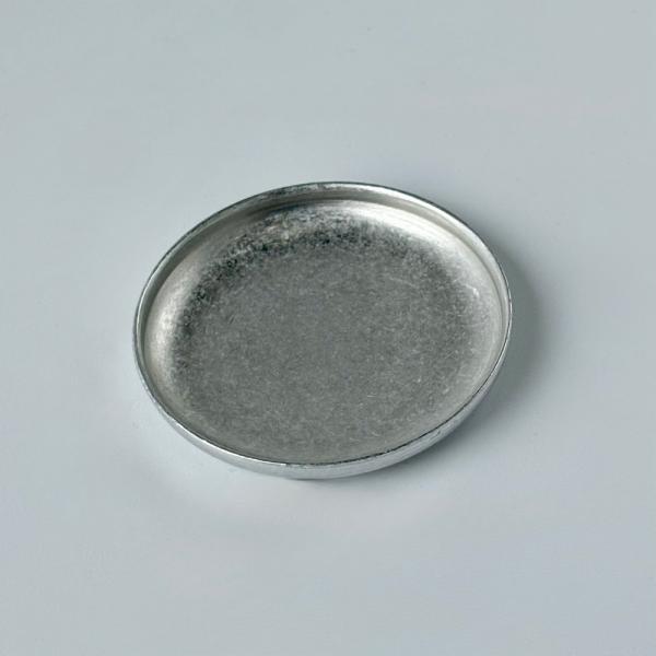 アルミニウムの素材感をいかし、加工で独特なざらつきと模様をつけた味わい深い趣のある直径4.5cmほどの豆皿です。ピアスやクリップを置いたり、小さなお香立てとしてもお使いいただけます。素材はアルミニウム無垢で、素地の風合いをそのまま活かしてい...