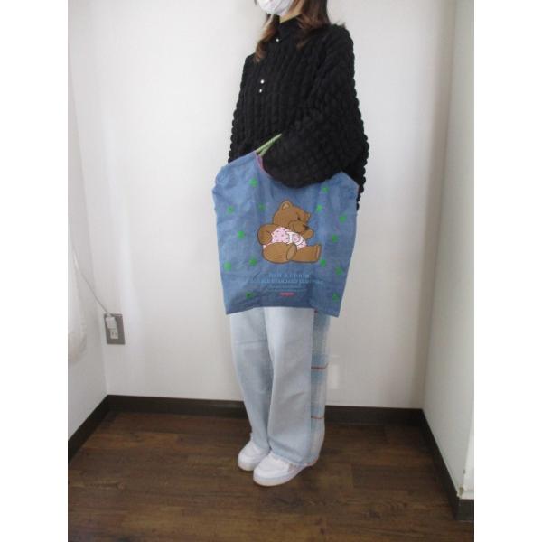 ダブスタでお馴染みのニジタロウが座ってポーズを取っているデザインのバッグです。ハート柄のお洋服で可愛らしく、周りのヤシの木柄刺繍がアクセント！デニム調のプリントは今回初デザインでキレイめなコーデに合わせて遊び心のあるスタイリングも◎バッグ本...