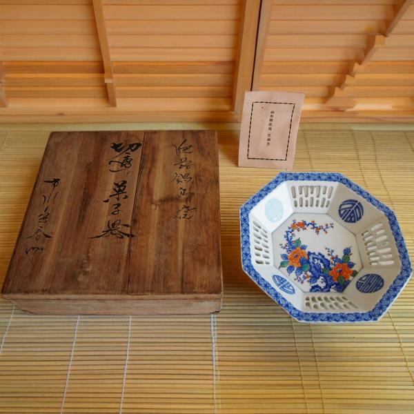 肥前鍋島焼 市川光春作 菓子器22ｃｍです。八角の縁起の良い意匠に鍋島伝統の櫛高台、柿右衛門様式の絵付け、淵に透かし高台内には佐賀藩（鍋島家）に纏わる杏葉紋の家紋があり鍋島の伝統を引き継ぎながらも新しい技術を随所に散りばめられた魅力あふれる...