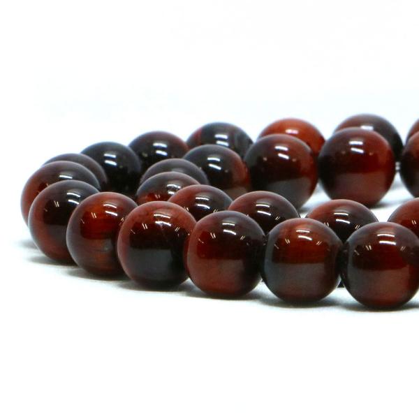 【ビーズサイズ】10mm【形】丸玉【連の長さ】約38〜40cm※ビーズサイズは0.5mm前後の誤差がある場合がございます【商品説明】和名では赤虎目石（あかとらめいし）と呼ばれます研磨されたタイガーアイの表面は光の角度によって特徴的な輝きを放...