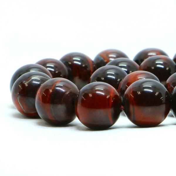 【ビーズサイズ】12mm【形】丸玉【連の長さ】約38〜40cm※ビーズサイズは0.5mm前後の誤差がある場合がございます【商品説明】和名では赤虎目石（あかとらめいし）と呼ばれます研磨されたタイガーアイの表面は光の角度によって特徴的な輝きを放...