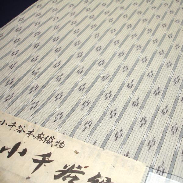 夏のきもの地、小千谷縮の反物です。麻100％、幅約38cm(1尺)×長さ約12.5m。◎さらっとした麻の特性と縮（ちぢみ）の風合いが相まった涼やかな織物です。◎生成色の地に経絣によって小模様を織り出しています。帯合わせにもよりますが、中年か...