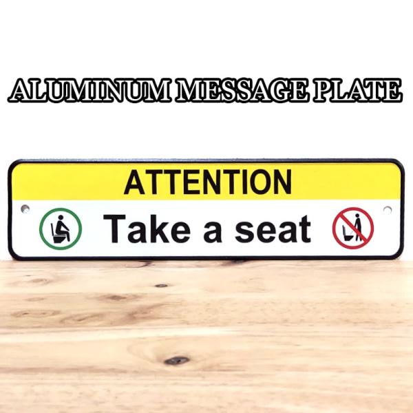 「アルミニウム メッセージプレート　ATTENTION -Take a seat-」アルミの板にプリントしたメッセージサインです。わかりやすいピクトグラム付きで、シンプルかつおしゃれなデザイン。アルミ製なので錆ず、また軽いので飾りやすいです...