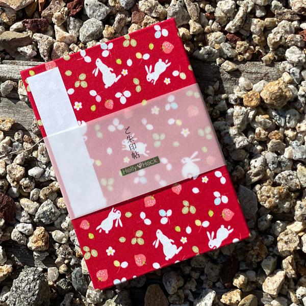朱印帳(納経帳)は神社や寺院でご朱印を頂く帳面になります。表紙はイラストレーター（Nico design 小林ゆかりさん）の作品でホリーホックオリジナルの御朱印帳です。赤地のいちご模様に白うさぎの模様。うさぎは「飛躍」や「繁栄」、「ツキ（月...