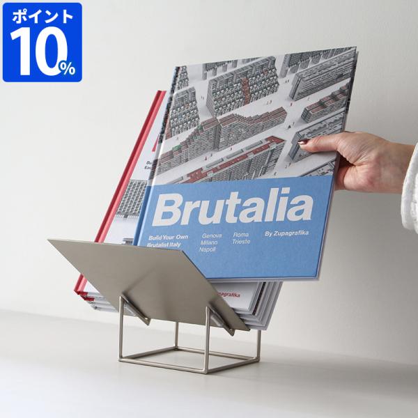 お気に入りの一冊を、空間の主役に。本やレコードを飾るためのミニマルな本立て「Tilaa Book Stand（ティラー ブック スタンド）」。2mm厚のプレートと細身のフレームを組み合わせた構造が、置いた作品の存在感を静かに引き立てます。視...