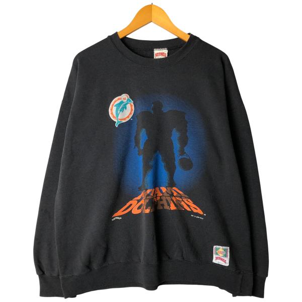 【コンディション】ランク：C【サイズ】着用感：メンズXL表記サイズ：XL着丈：66cm身幅：66.5cm肩幅：61cm袖丈：53cm【商品詳細】商品名：古着 90年代 ナツメグ NUTMEG NFL MIAMI DOLPHINS マイアミド...