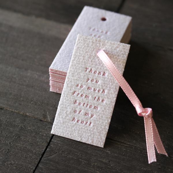 モコモコとした手触りのグレーの起毛紙に活版印刷で制作したサンキュータグです。裏地には印刷カラーと同系色でクロコ調のテクスチャがユニークな紙を貼り合わせております。紙質と活版印刷特有の凹んだ文字がとても個性的なタグに仕上がっております^^プレ...