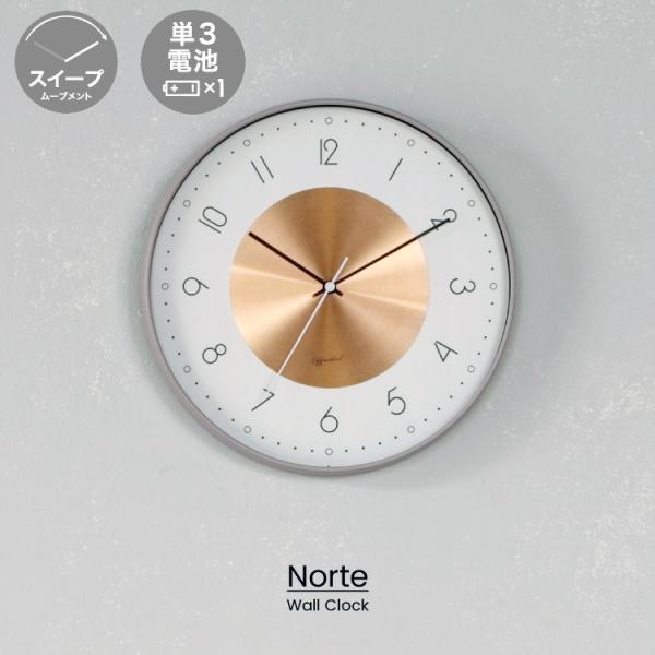 中央にあしらわれたコッパーのプレートがさりげなく輝く壁掛け時計。ウォームグレーのスリムなフレームとフェミニンな文字盤がマッチした上品なデザインです。丸みのある数字とインデックスのドットが、モダンな雰囲気にマッチします。前面にはガラスがはめ込...
