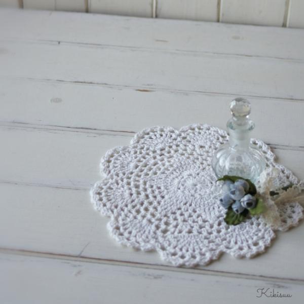 やわらかなオフホワイトの糸で編まれた、手編みのドイリーです。お気に入りの小瓶やドライフラワーの下などに置いて、空間にやさしい穏やかな雰囲気を添えてくれます。白い商品との色の比較は画像を参考にしてください。サイズ　直径約18〜20cm素材　綿...