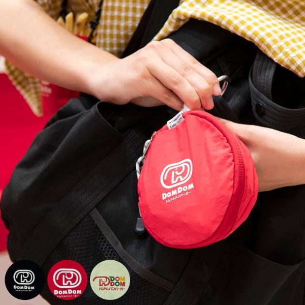 サイズ/約奥行5cm直径：約15cm材質/ナイロン種類/BLACK、RED、WHITE生産国/中国製●DOMDOM（ドムドムハンバーガー）× DAYOUTのコラボによる、マルチハンバーガーケースです。●カラビナ付きで、テイクアウトしたハンバ...