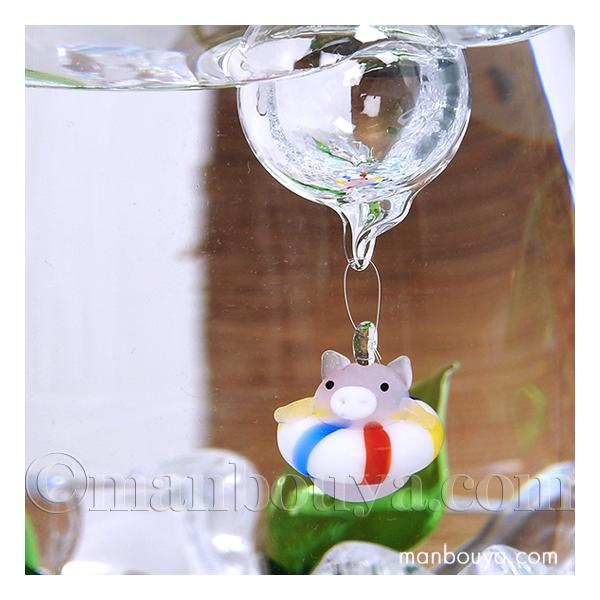 浮き玉がついたフローティングタイプのミニチュアガラス細工。金魚鉢や水槽に入れるとぷかぷかと浮く、豚のオブジェです。浮き輪をつけた丸いピンクのブタさんがかわいいデザイン。海の生き物やサンゴなどの置物や、他の浮き球と合わせるとユニークなインテリ...