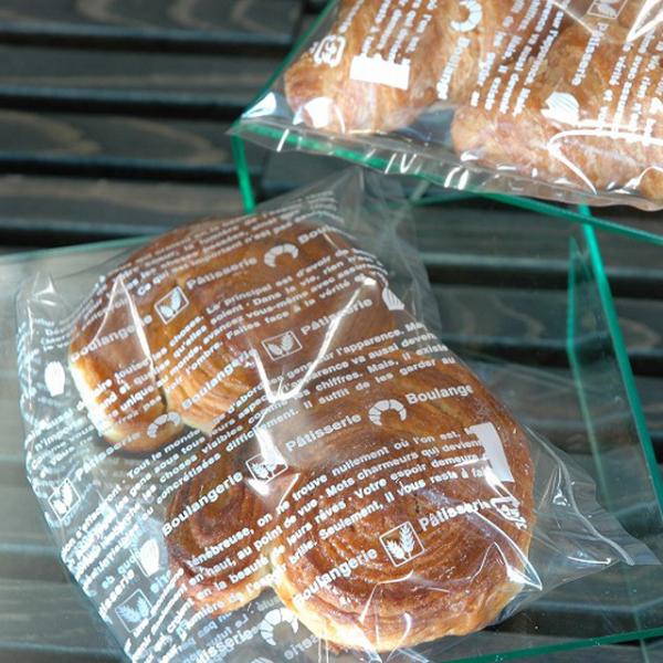 ポイント使いのイラストがキュートな透明パン用個包装袋です。PP袋は柔らかさとハリが適度にある透明感の高いフィルムです。リーニュとはフランス語でライン（＝線）のこと。リーニュ柄にはクロワッサン、マドレーヌ、麦の穂がフランス語とともに描かれた柄...