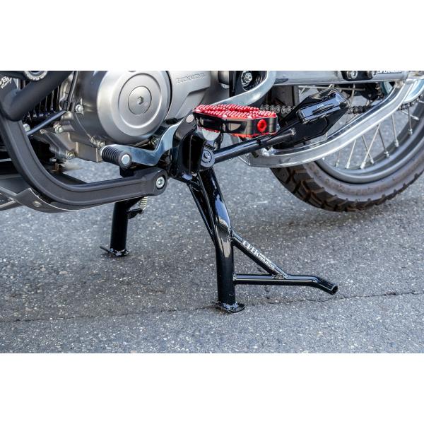 対応車種 [CT125(23-)/HONDA(ホンダ)]メーカー：OVER Racing -オーヴァーレーシング-・ワイドセンタースタンド本体・ブラック塗装仕上げ※OVER製ダウンマフラー装着不可純正全幅と比べ約50mm広く設計されたセンタ...
