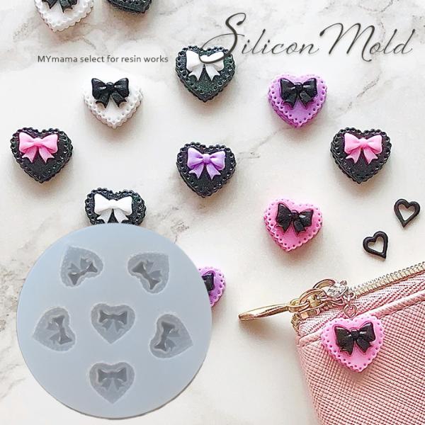 シリコンモールドハート 飾り リボン モチーフ#ゆうパケ24点可小さなハートにリボンが飾られたパーツが作れるシリコンモールドです。ハートがレースの様なデザインなので細かくてとってもおしゃれ！小さめモチーフなのでファスナーの飾りにしてもかわい...