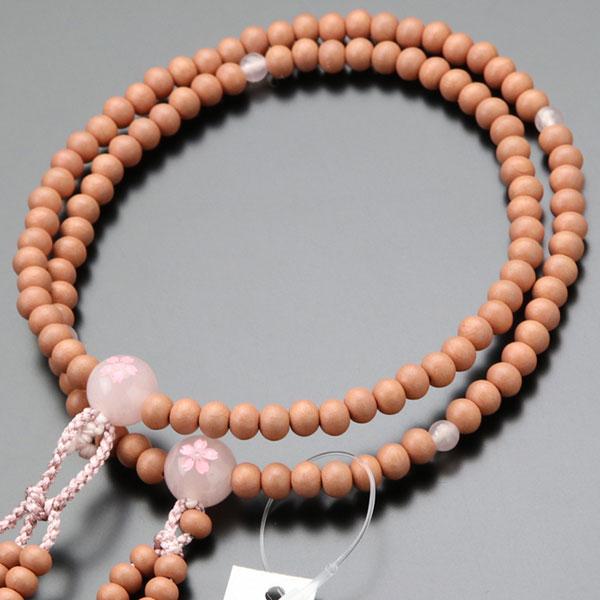 日蓮宗、女性用の正式なお数珠でございます。京都の数珠職人である、法珠庵・吉村珠道作のこだわりのお数珠。素材は、国産の和桜を使用した、薄っすらと桃色がかった紅桜でございます。アクセントには、ローズクォーツを使用させて頂きました。親玉の表面と裏...