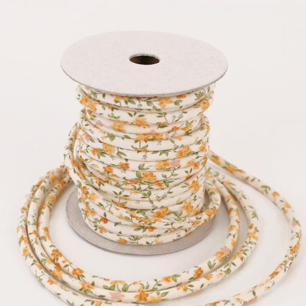 ■表地：綿100%　中芯：アクリル100%※10cm単位で販売、価格は10cm分。数量は10cm単位で入力して下さい(例:1m購入なら数量10)。お庭に咲いているようなお花たちが木綿の丸ひもになりました。小さな柄でとにかくカワイイ！洋風なデ...