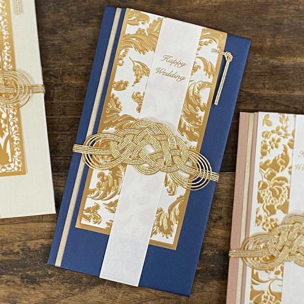 華やかでやわらかい印象の結婚祝いのご祝儀袋です。ゴールドの装飾と伝統的な水引飾りが二人の門出を彩ります。色ごとに縁起の良いモチーフが、箔押しエンボス加工であしらわれてます。クリームには、豪華絢爛なアラベスク模様。「繁栄」を意味する唐草などの...