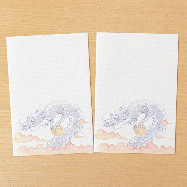 雲を突き抜けて現れた龍を描いた年賀はがき2枚セットです。ひげ や たてがみが風になびいて、静かな躍動感がみなぎります。宛名面には「年賀」の印字があります。イラストのある面はキラ入りで角度によってさりげなく光ります。柔らかな表情のある紙で、ペ...