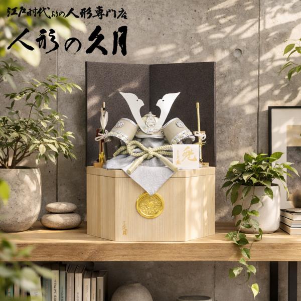 【東京浅草橋 人形の久月】久月の五月人形 ”コンパクト収納飾り”です。１つ１つ丁寧に造られた鋲打ち星兜。 その兜は伝統工芸品に指定されています。 また、32cm幅とサイズもコンパクト。ナチュラルウッドの収納箱にくすみカラーの兜がおしゃれです...