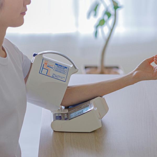 腕を通すだけで正しい測定姿勢を作る「可動式腕帯」。全自動巻き付け腕帯で、一人ひとりの腕にあわせた最適加圧。10分以内に測定された測定記録（最大3回）の平均測定値を表示。朝の1週間の平均値が「135/85mmHg」を越えると「早朝高血圧マーク...