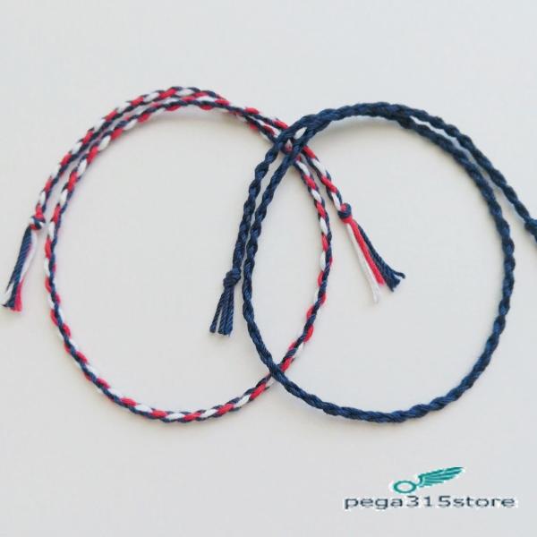 長さ：約３５ｃｍ（三つ編み部分：6.5ｃｍ　センター部分：19ｃｍ）素材：刺繍糸色：紺２・赤・白　　紺単色　　計4本の四つ編みです。細く重ね付けに♪※お使いの液晶によってお色味が若干異なる事がございます。ご心配な方はコメント下さい。丁寧、迅...