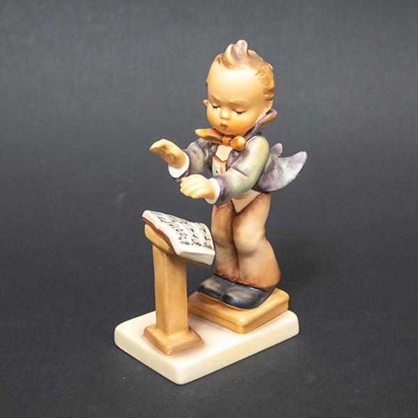 『Band Leader（指揮者さん）』と題されたゲーベルのフンメル人形（陶器人形）。タキシードを着て譜面台の前で指揮をとる少年がモデル。"指揮者"のことをドイツ語では"Kapellmeister（カペルマイスター）"というそうです。フンメ...