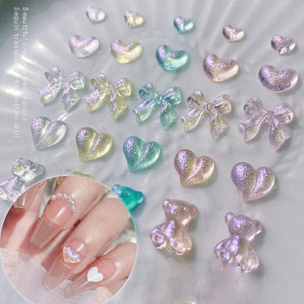 オーロラカラーにラメ入りのかわいい今時レジンパーツ春夏ネイルにぴったりです。カラーランダムですので予めご了承くださいませ。■素材：樹脂■数量：5個■ビニールパケ入り■原産国：中国※お子様の手の届かない所に保管して下さい。※パッケージ等は予告...