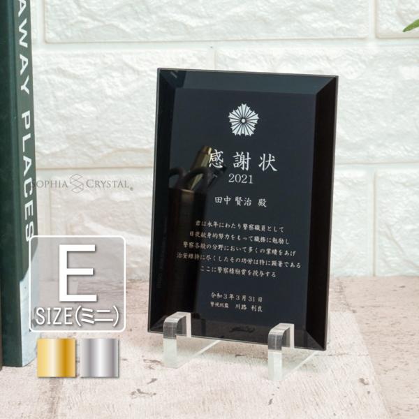金/銀の文字と美しいデザインが上品に輝く、漆黒の表彰盾です。周年記念や社内表彰、取引先表彰、認定証、感謝状などに人気です。■サイズ【ミニE】高14cm×幅10cm×奥0.6cm■包　装：簡易箱(ボール箱)入り、アクリル台座付き【当社商品のご...