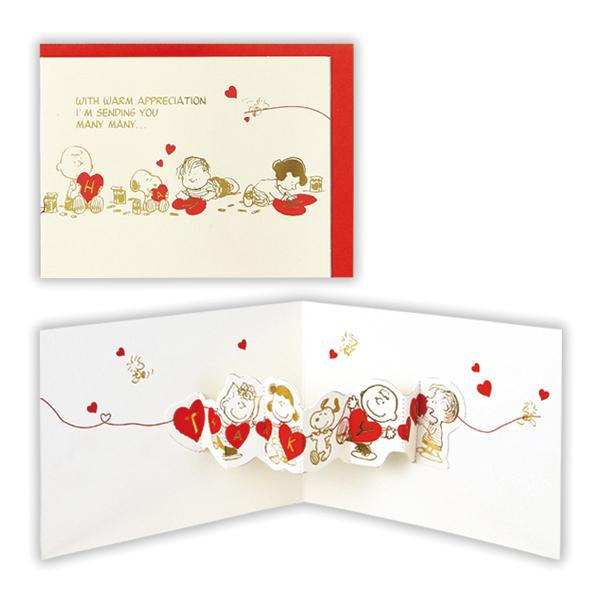 ひと言添えるだけで贈れるサンキューカード。スヌーピーと仲間たちが繋がるハートフルなデザインです。コミックの手書き線を金箔で表現しています。表：WITH WARM APPRECIATION. I'M SENDING YOU MANY MANY...