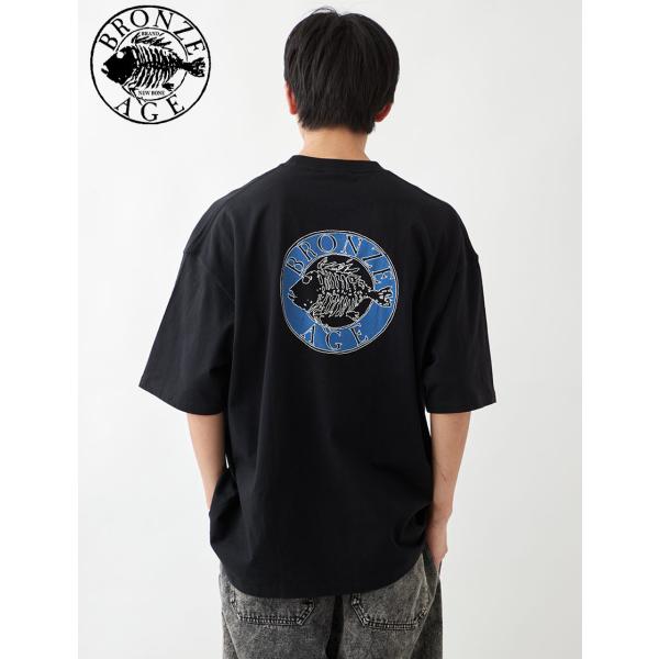 BRONZE AGEのTシャツ。ビッグシルエットです。ブランドアイコンであるスカルフィッシュのサークルロゴをフロント左胸とバックに配置。着抜プリントの手法を用い、独特のかすれ具合が古着っぽさを演出します。トレンドのストリートスタイルはもちろ...