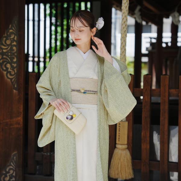 グリーンとクリームの糸で編み込まれたモザイク風の幾何学デザインの薄羽織です。一見薄地の生地ですが、よく見ると細かなレース仕立てになっています。春先から秋口まで長い期間お使いいただける単衣の羽織になります。※羽織紐は付いていません。※非常にデ...