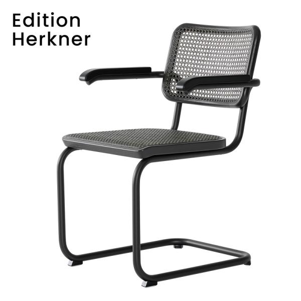 「Edition Herkner」のS64Vは、クラシックなカンチレバーチェアの現代的アレンジです。デザイナーSebastian Herknerが手掛け、座面には深みのあるダークメランジェカラーのケーン（籐編み）を用いた仕様です。フレームと...